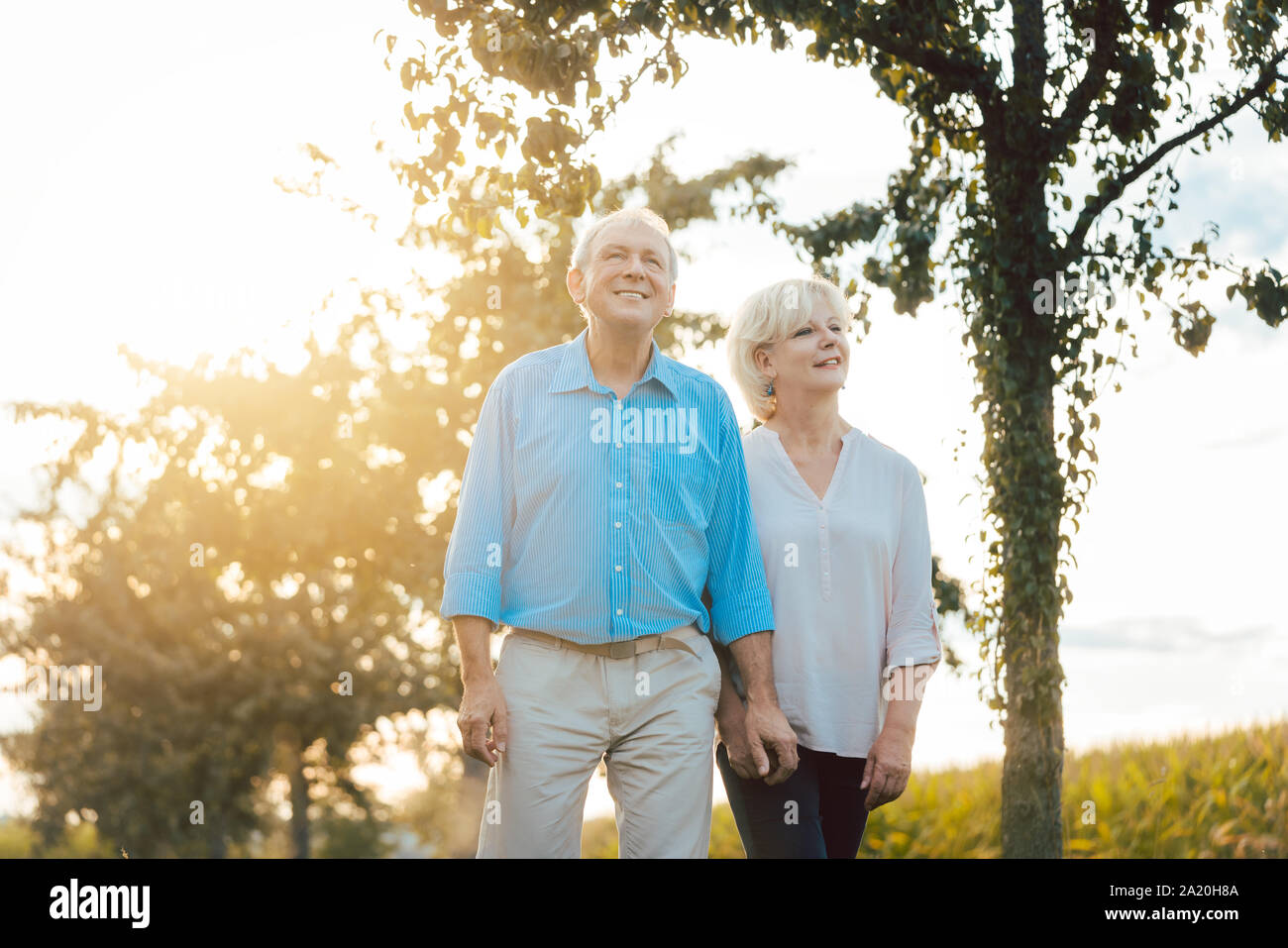 Senior woman and man having a walk along path in the countryside Stock ...