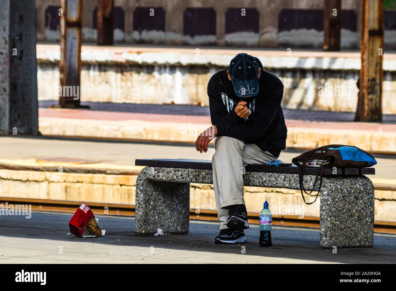Man sitting on a bench, waiting train on the platform of Bucharest ...