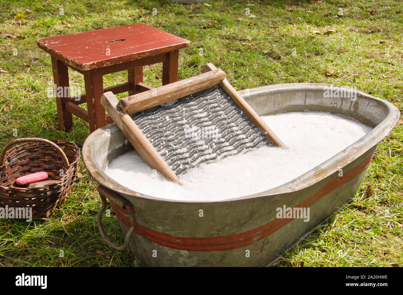 An old fashioned washing trougth a vintage child chair, and wooden ...