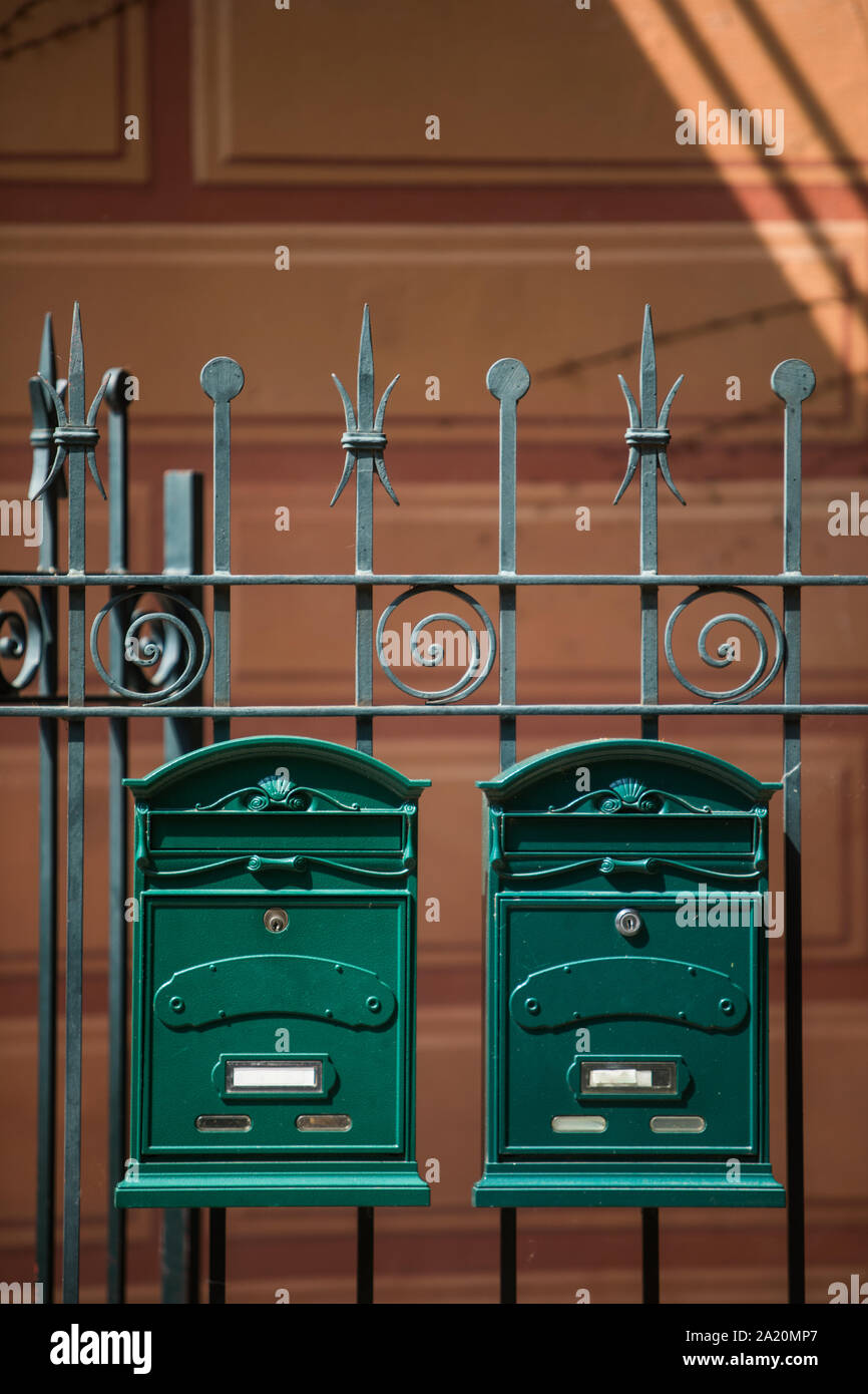 Two vintage green mail boxes on a fence Stock Photo - Alamy