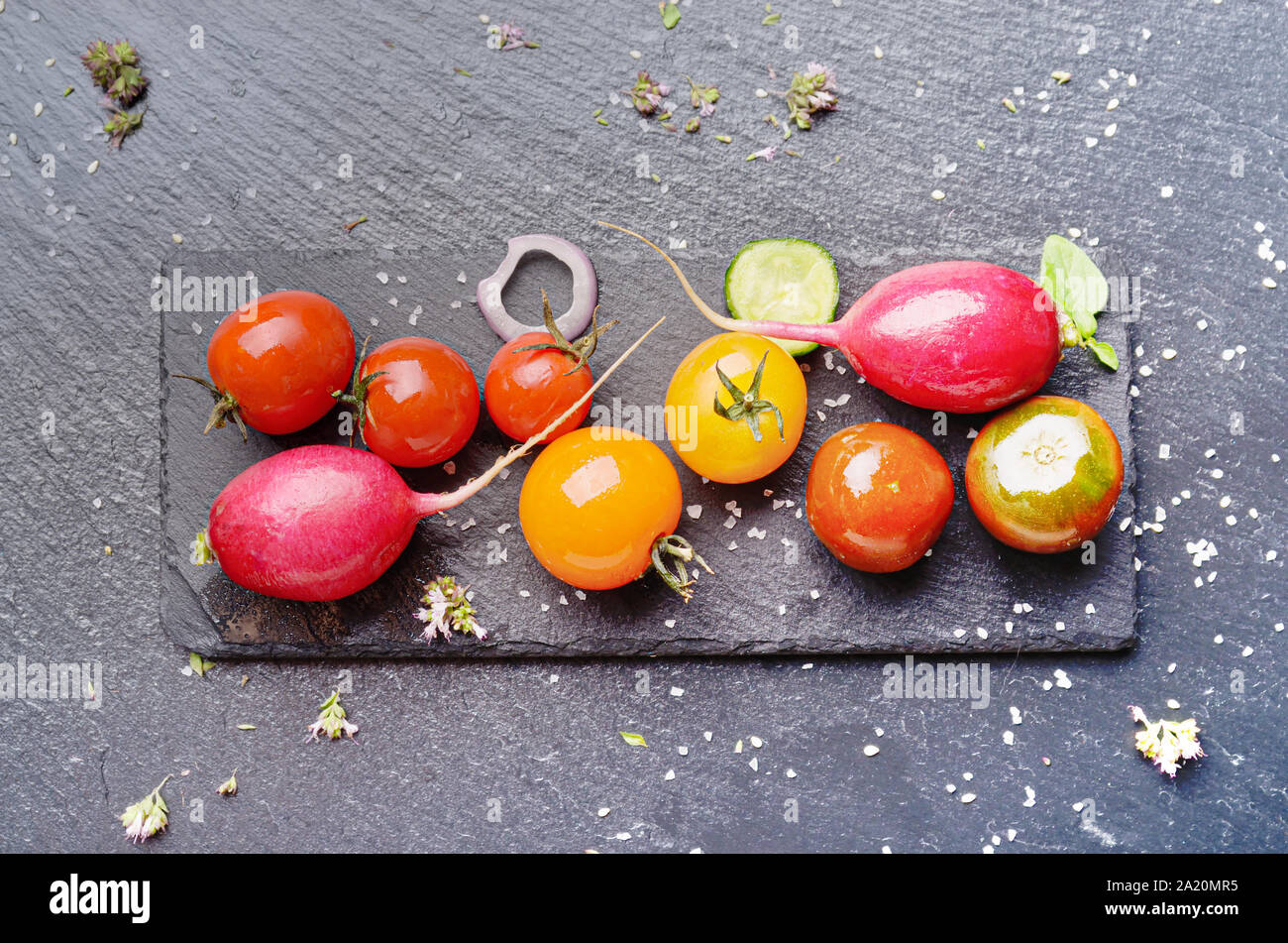 Top view at fresh organic vegetables on slate stone tray with spices ...