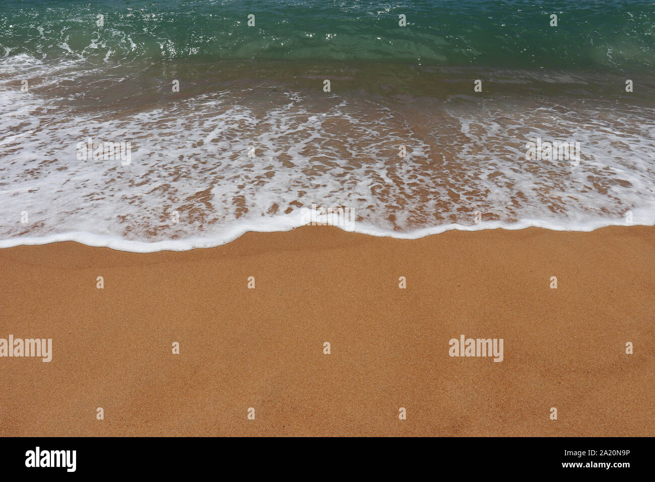 Azure wave with sea foam on a sand. Picturesque seascape with clear ...