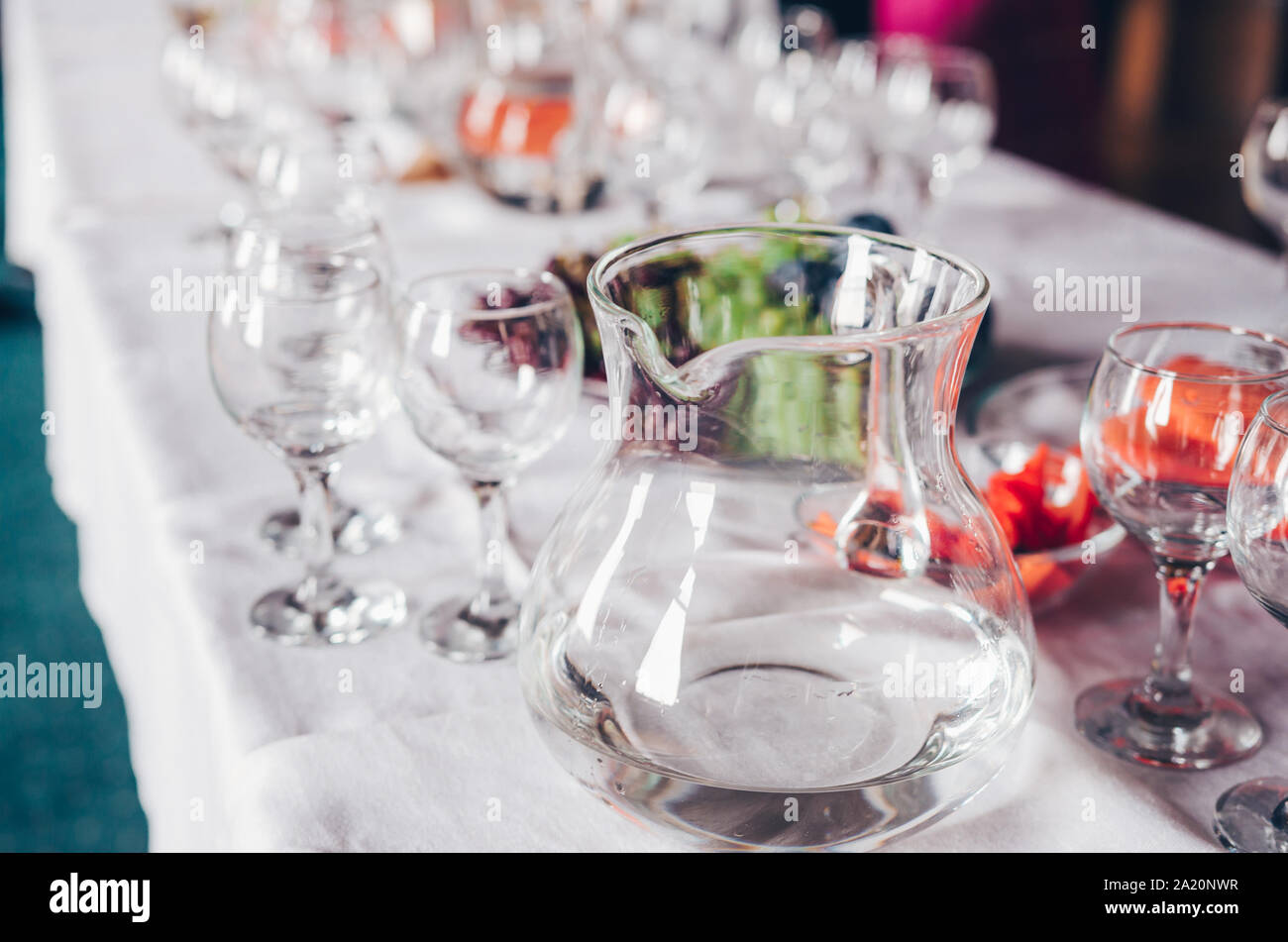 Serving food and drinks at event. Buffet table with water and fruits ...