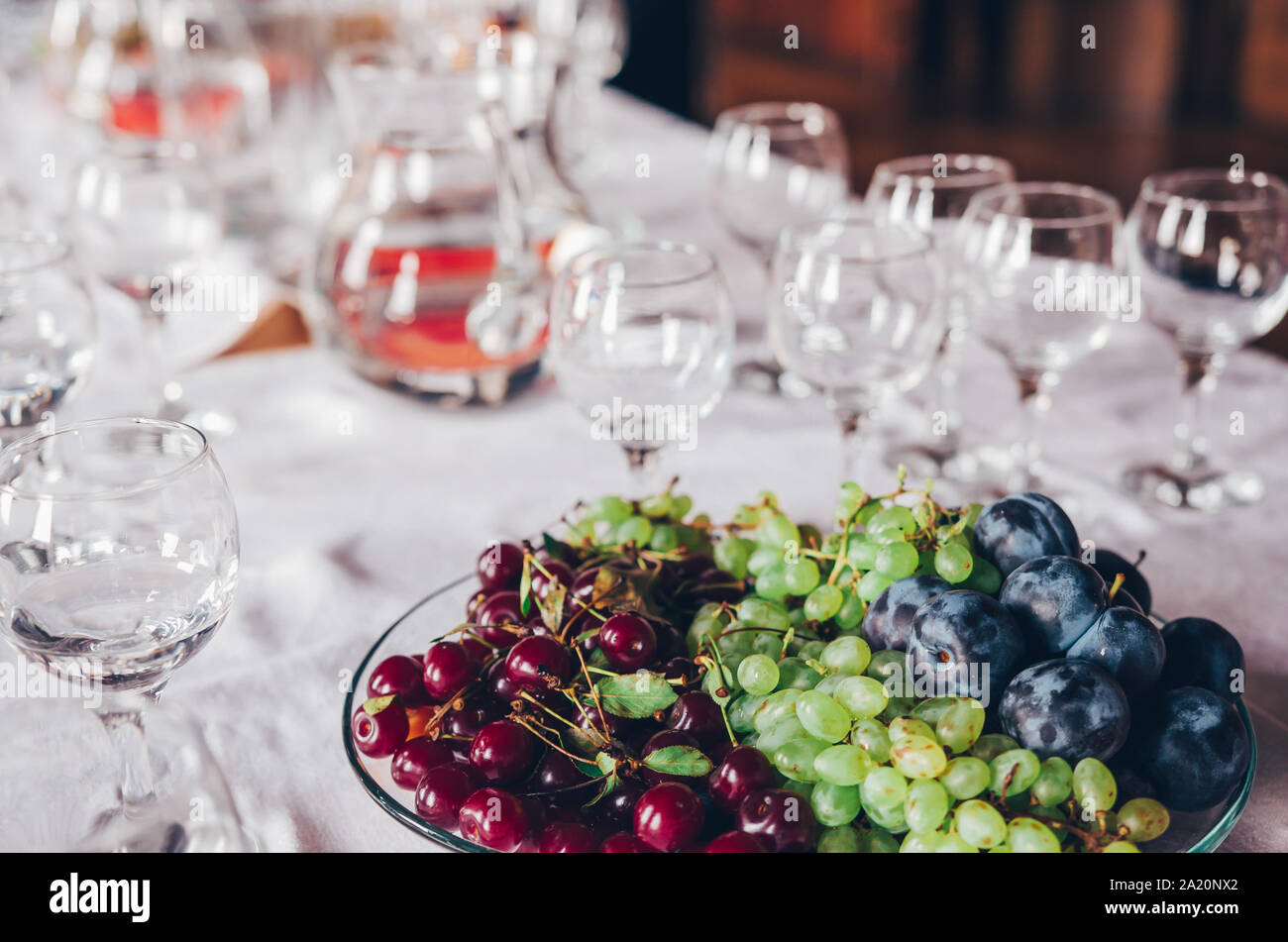 Serving food and drinks at event. Buffet table with water and fruits ...