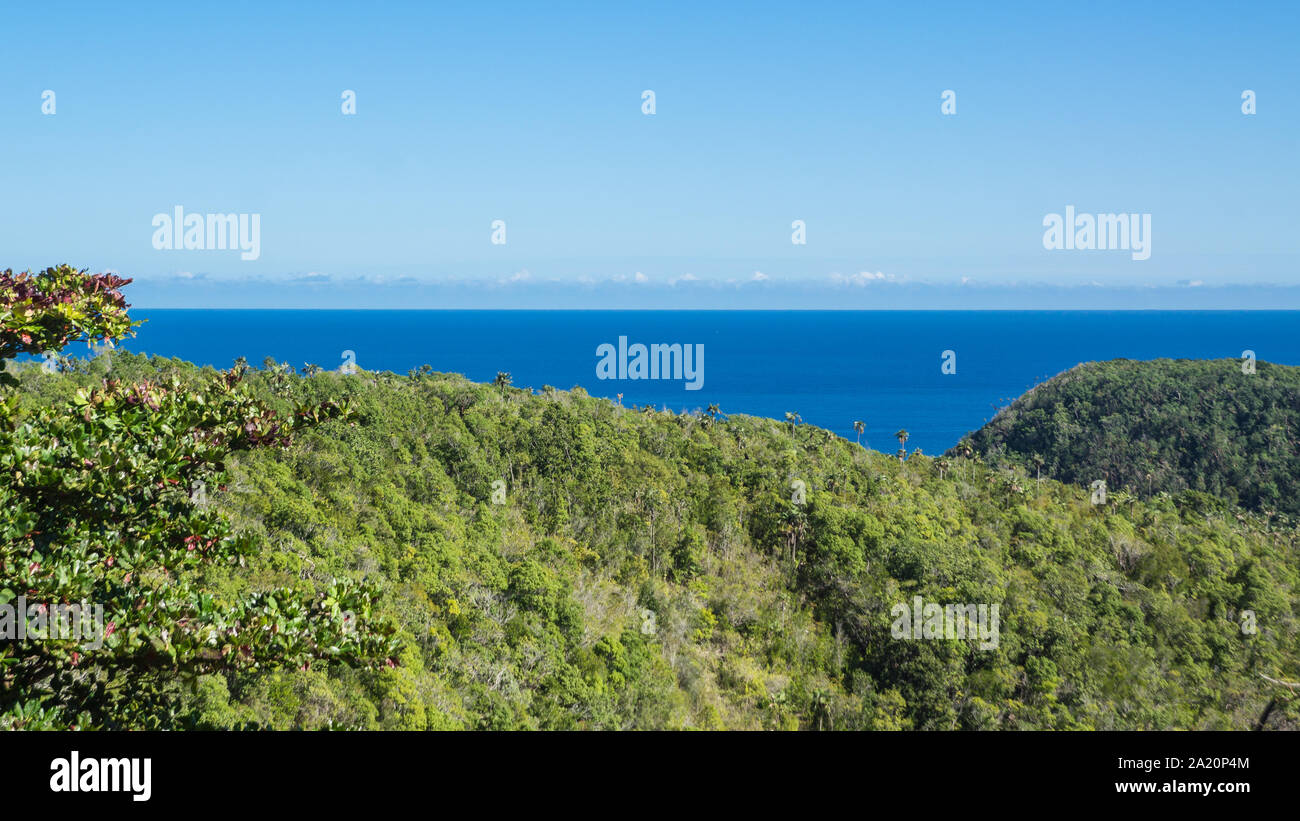 Panoramic view over the jungle at Cuba's coast. Green hills to the blue ...