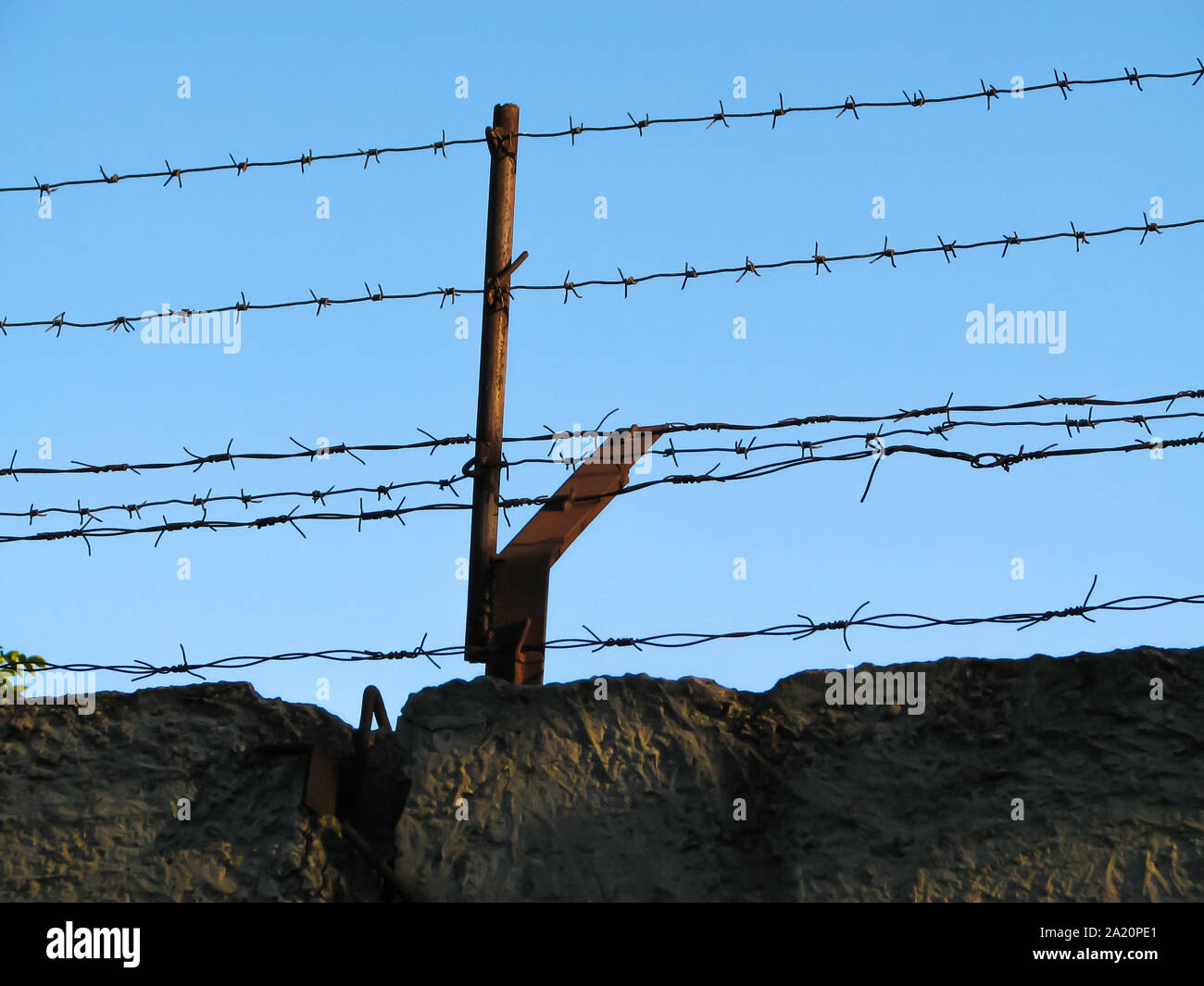 Two lines of rusty monobasic barbed wire and several lines of rusty ...