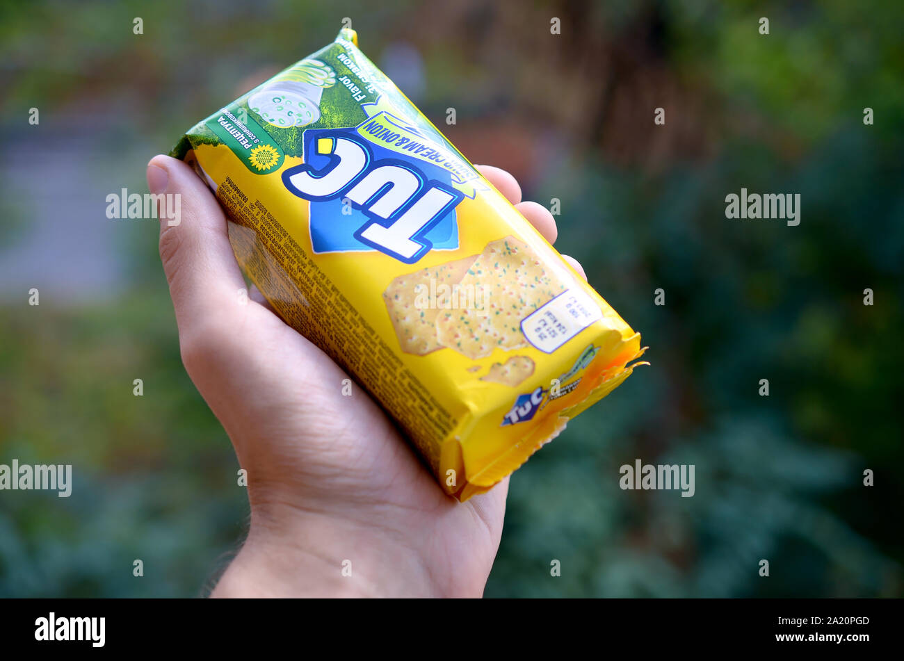 KHARKOV, UKRAINE - SEPTEMBER 23, 2019: Tuc snack pack in male hand on a ...