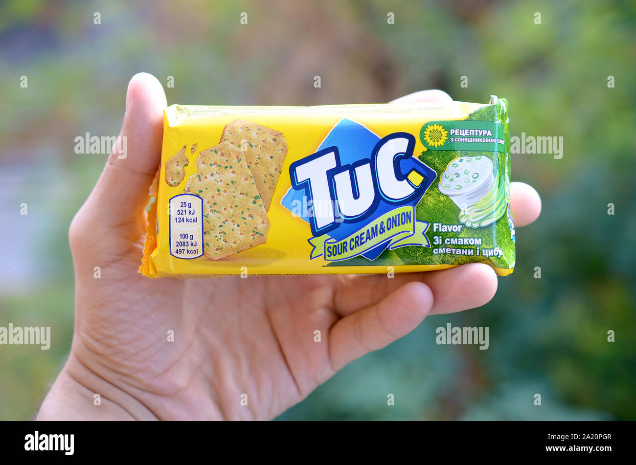 KHARKOV, UKRAINE - SEPTEMBER 23, 2019: Tuc snack pack in male hand on a ...