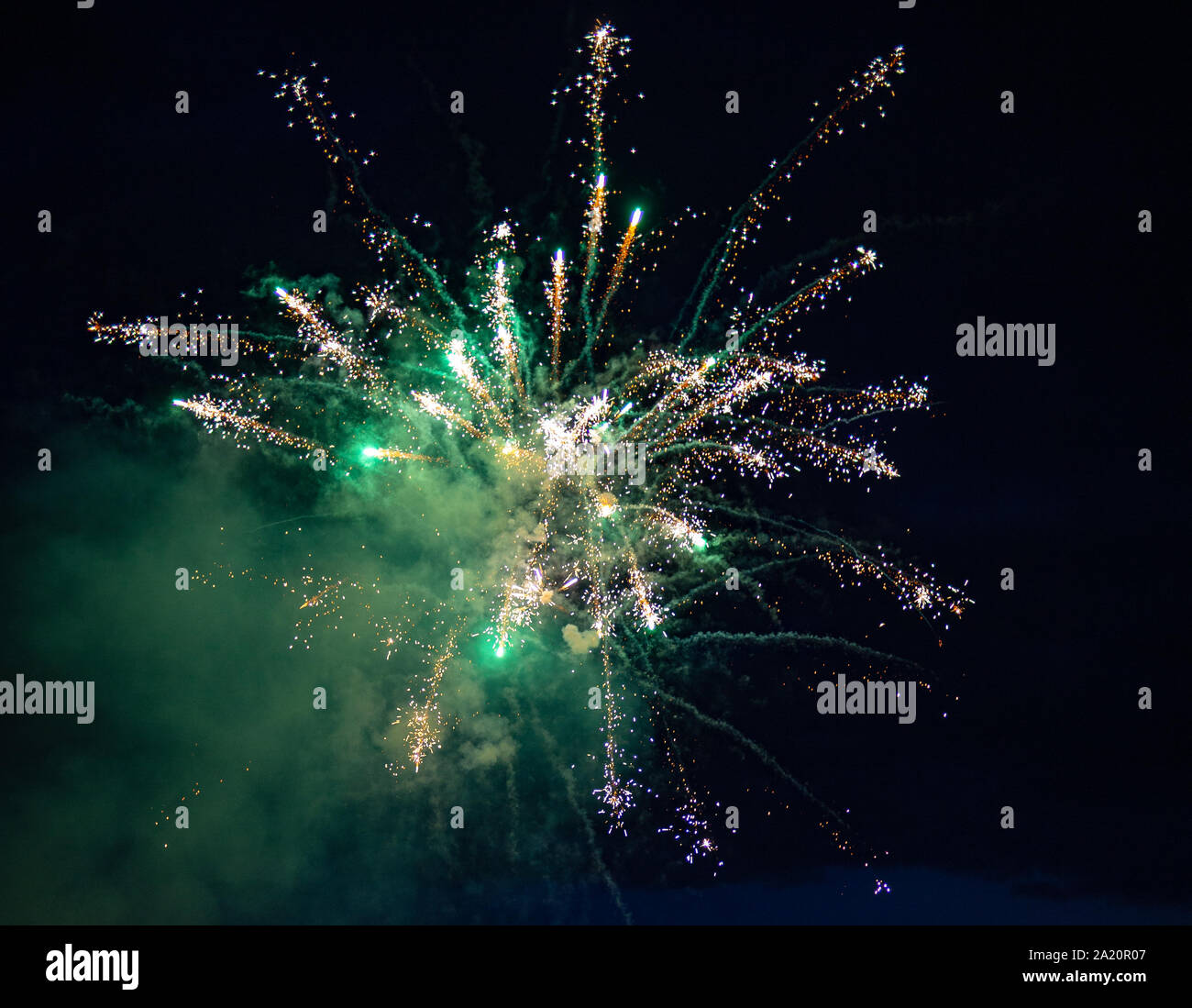 Firewoks, explosion - sparks blurred by speed. Evening sky in ...