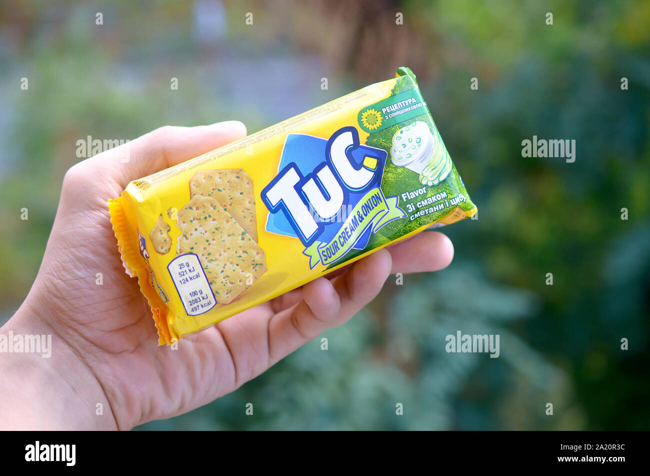 KHARKOV, UKRAINE - SEPTEMBER 23, 2019: Tuc snack pack in male hand on a ...