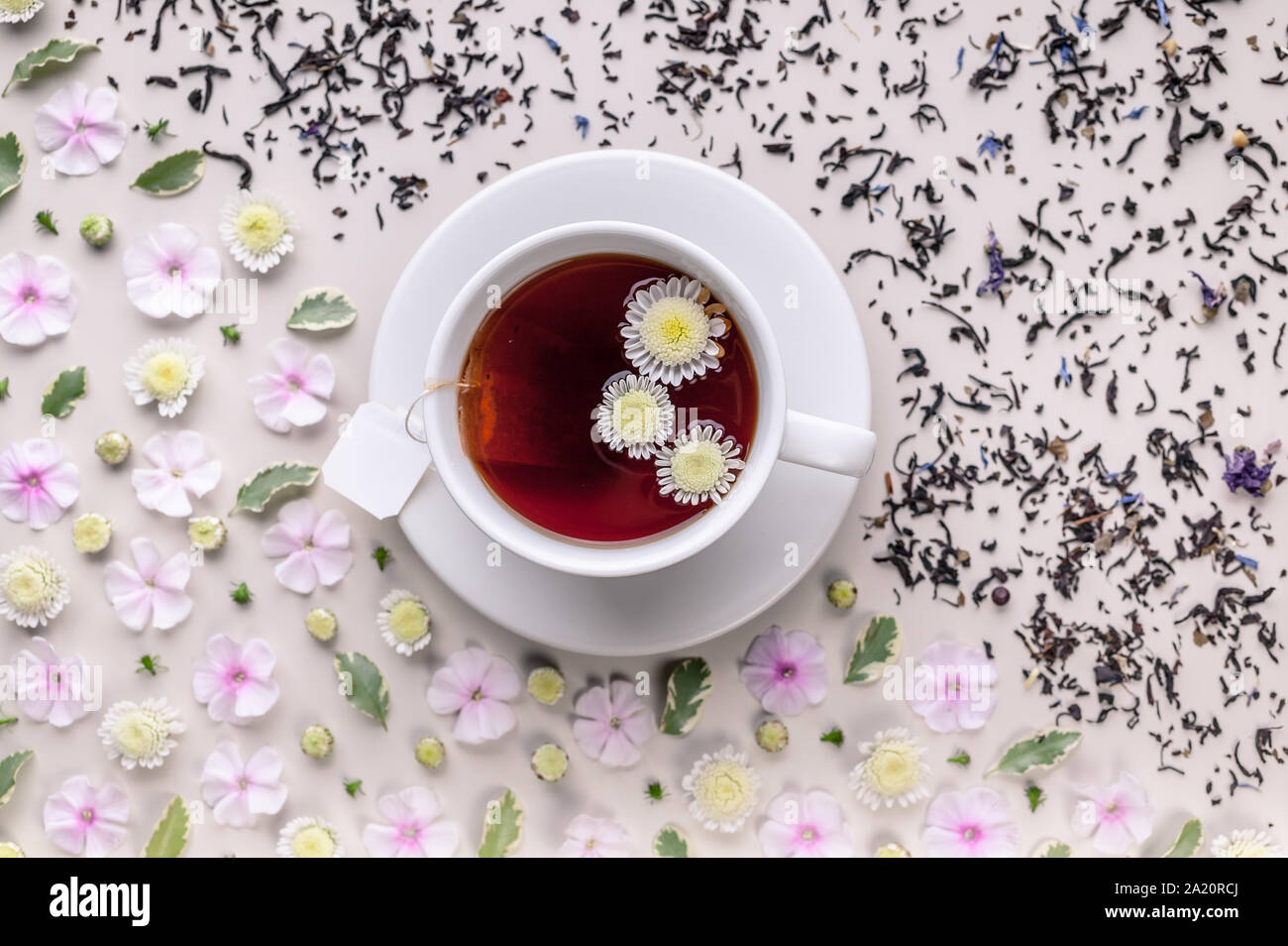 Flavored herbal tea in a white ceramic cup with a saucer. Floral ...