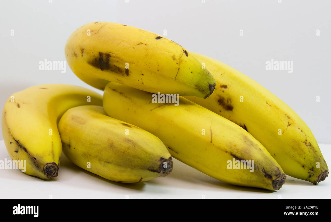 overly ripe bananas on white table with white background Stock Photo ...