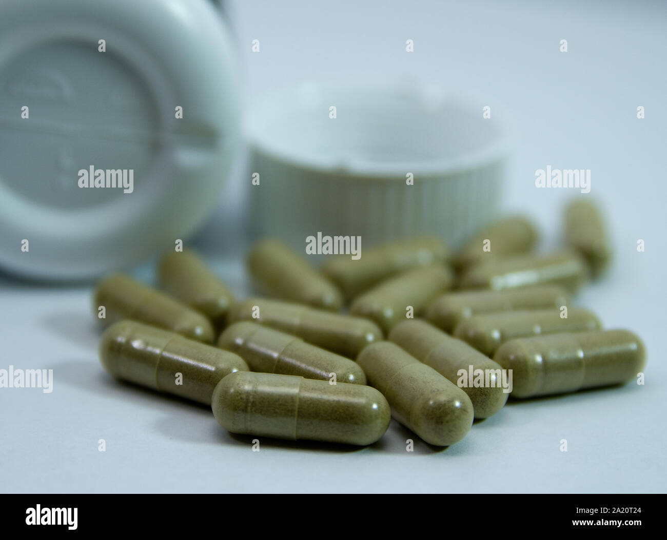 natural herb capsule supplement with white background Stock Photo - Alamy
