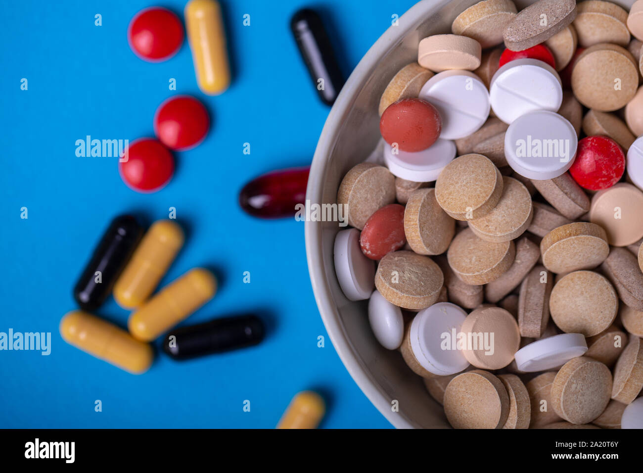 Close up with pills of different colors and shapes. Macro and red color ...