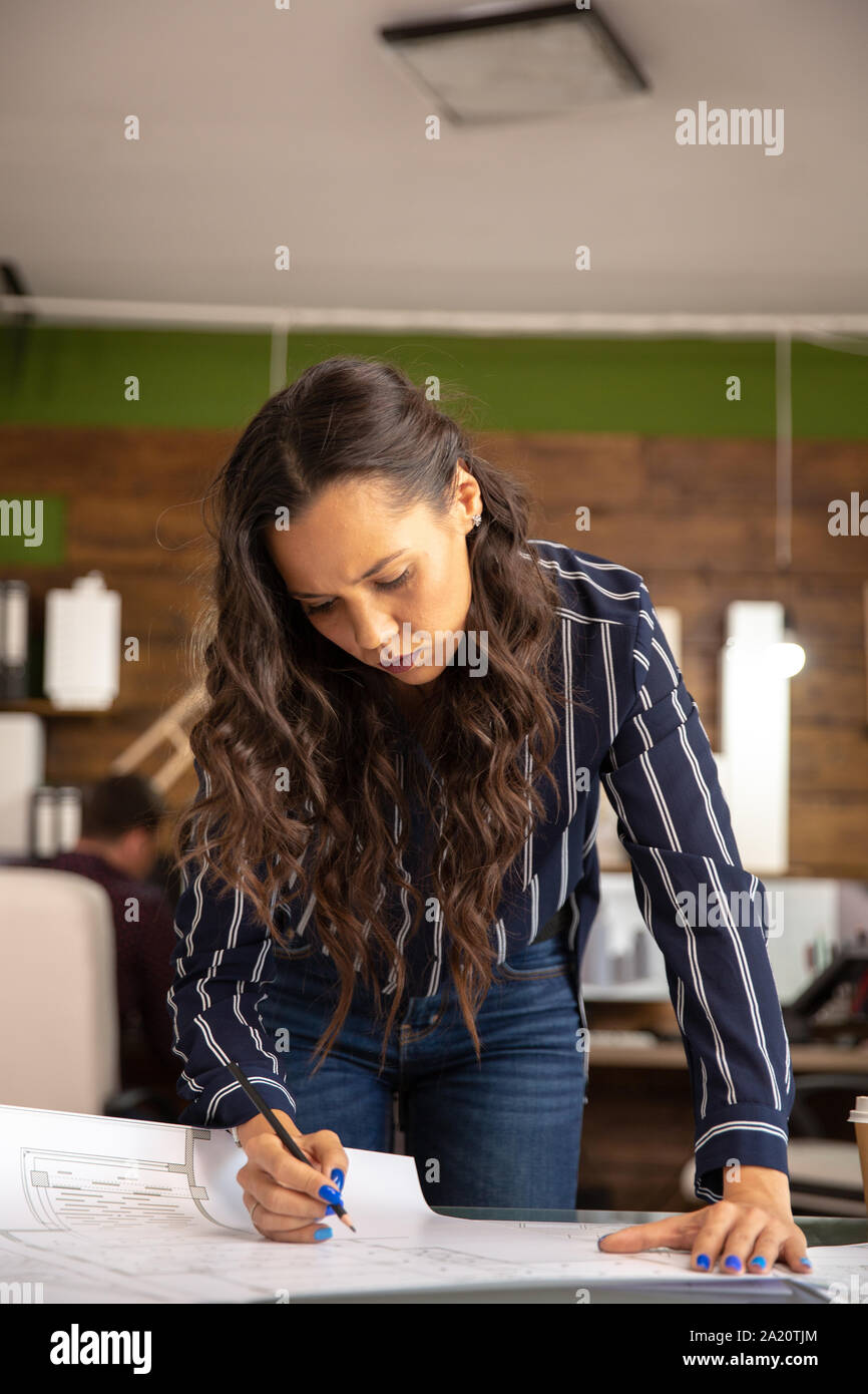 Businesswoman making blueprint desk hi-res stock photography and images ...