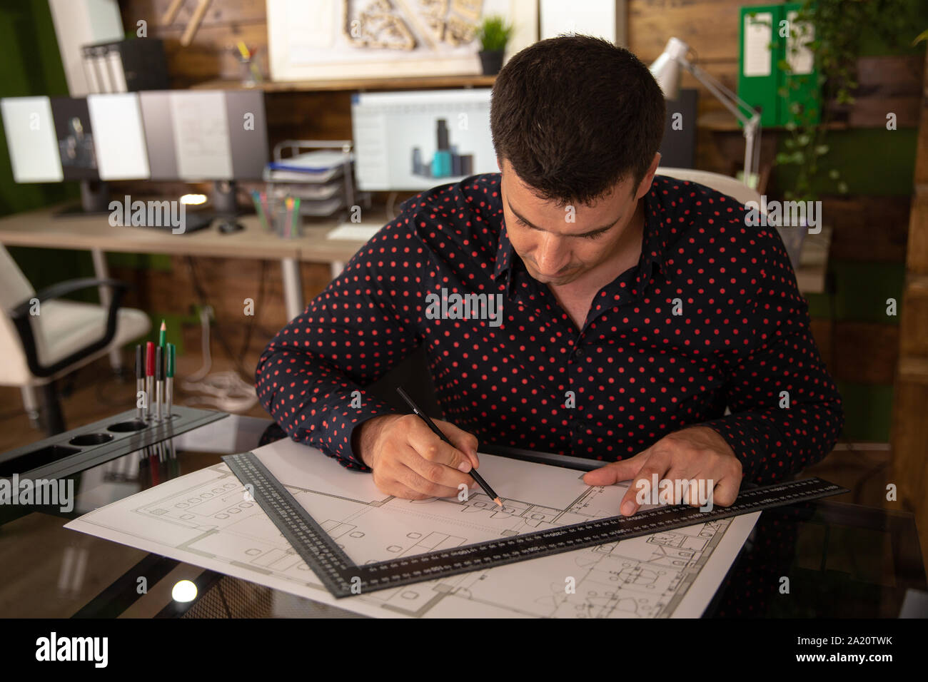 Male architect drawing a new project on the sheet. blueprints and paper ...
