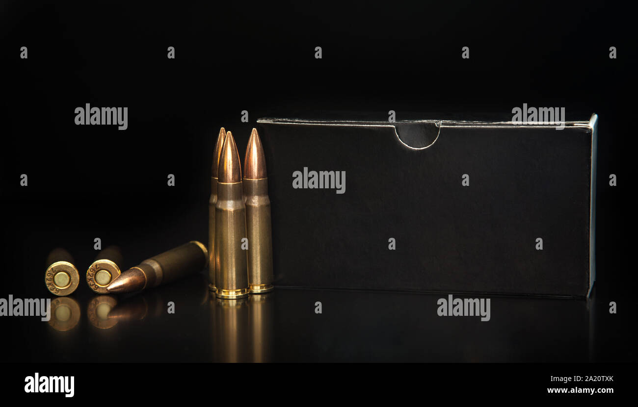 Bullet isolated on black background with reflexion. Rifle bullets close ...