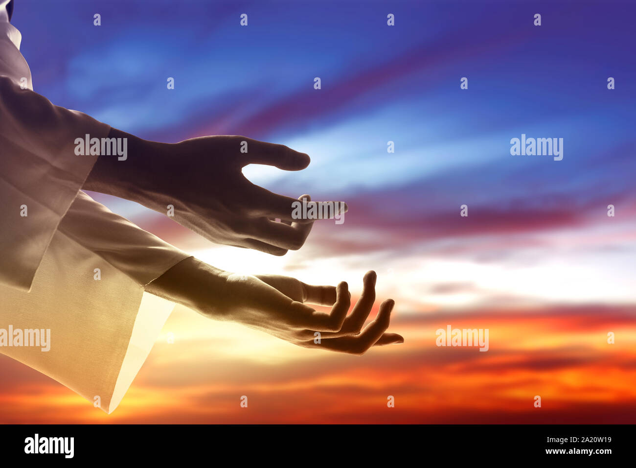 Jesus Christ praying to god with a sunset sky background Stock Photo ...