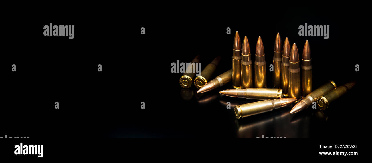 Bullet isolated on black background with reflexion. Rifle bullets close ...