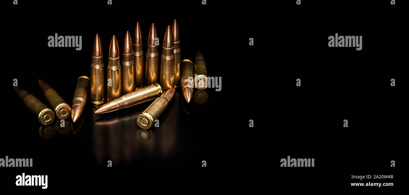 Bullet isolated on black background with reflexion. Rifle bullets close ...