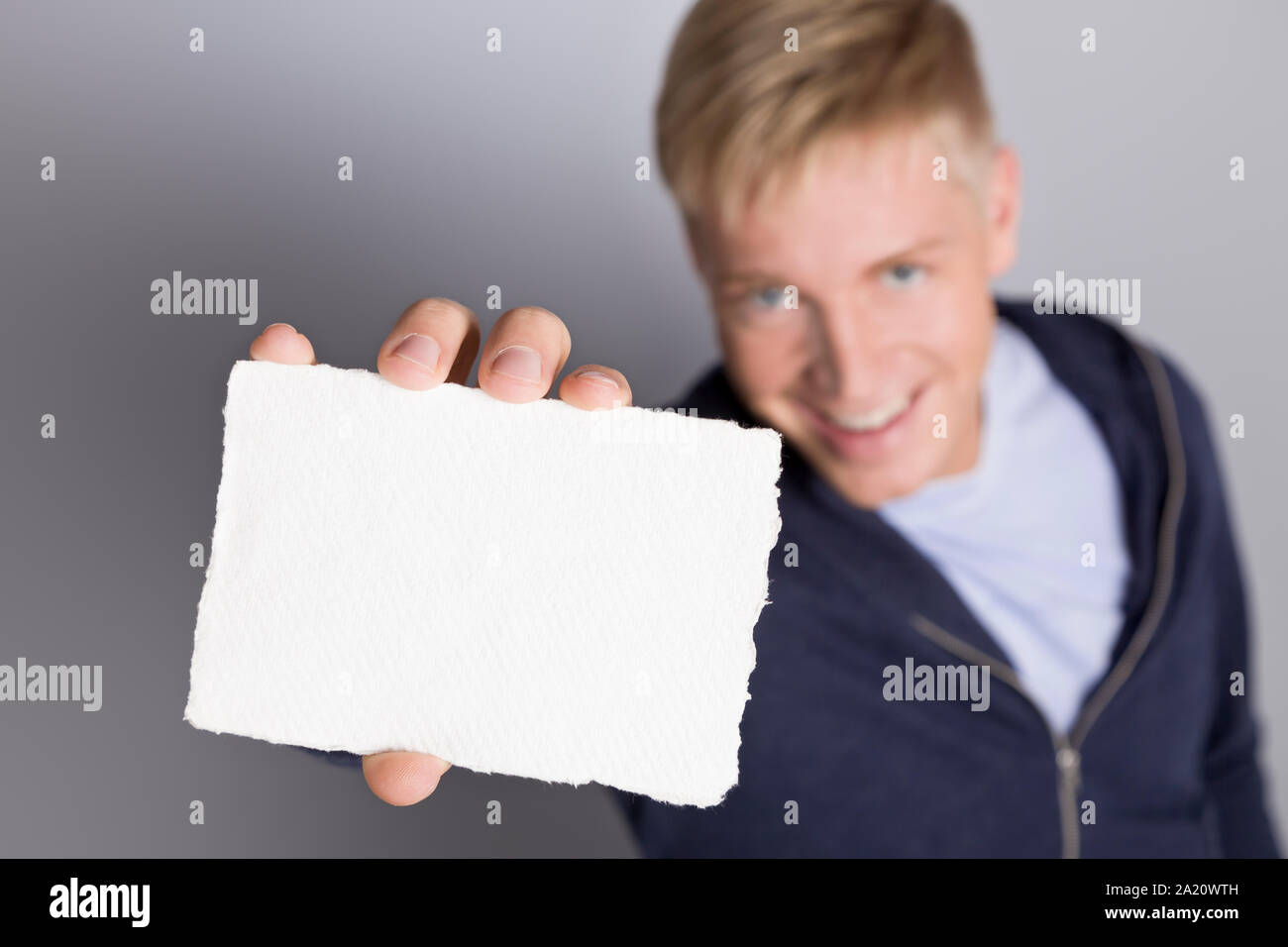 Joyful man showing empty white card Stock Photo - Alamy