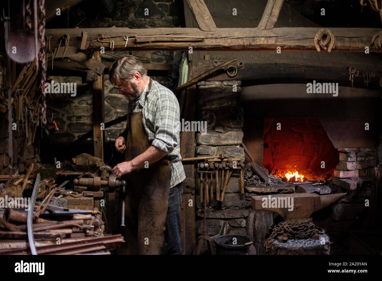 A blacksmith at work at St Fagans National Museum of History Stock ...