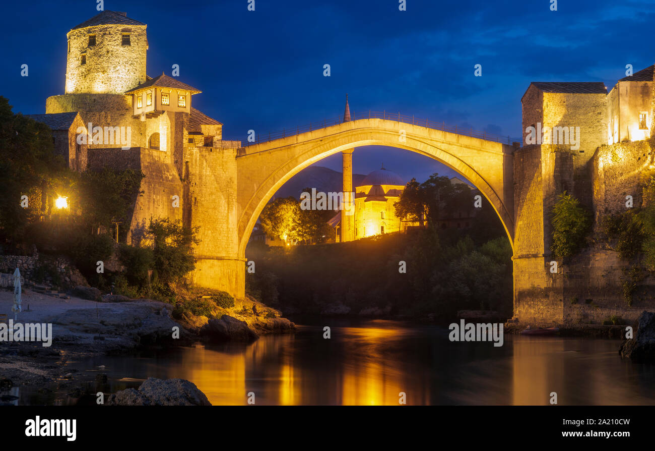Old bridge and panorama of Mostar by night Stock Photo - Alamy