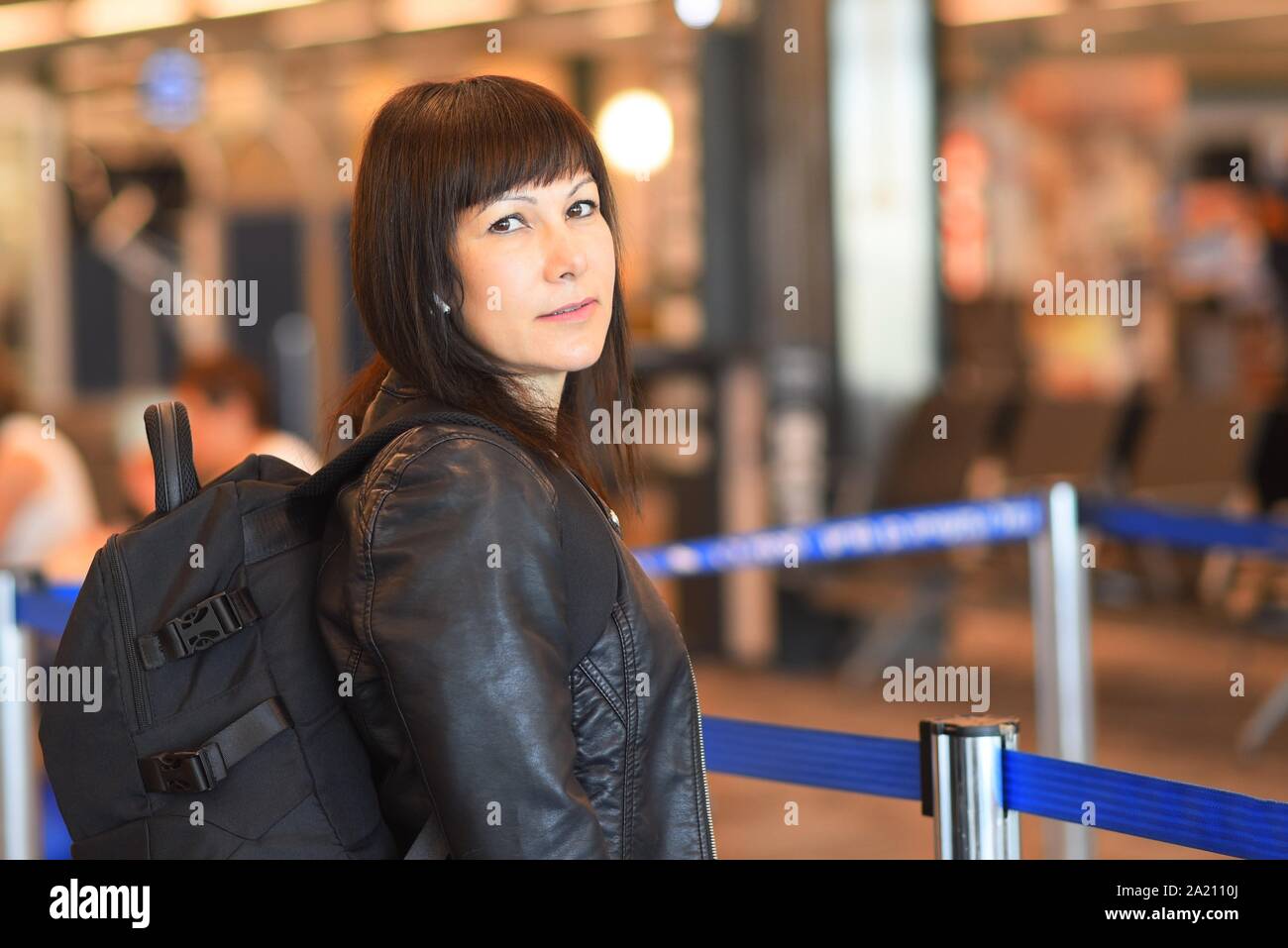 Woman backpack in international airport hi-res stock photography and ...