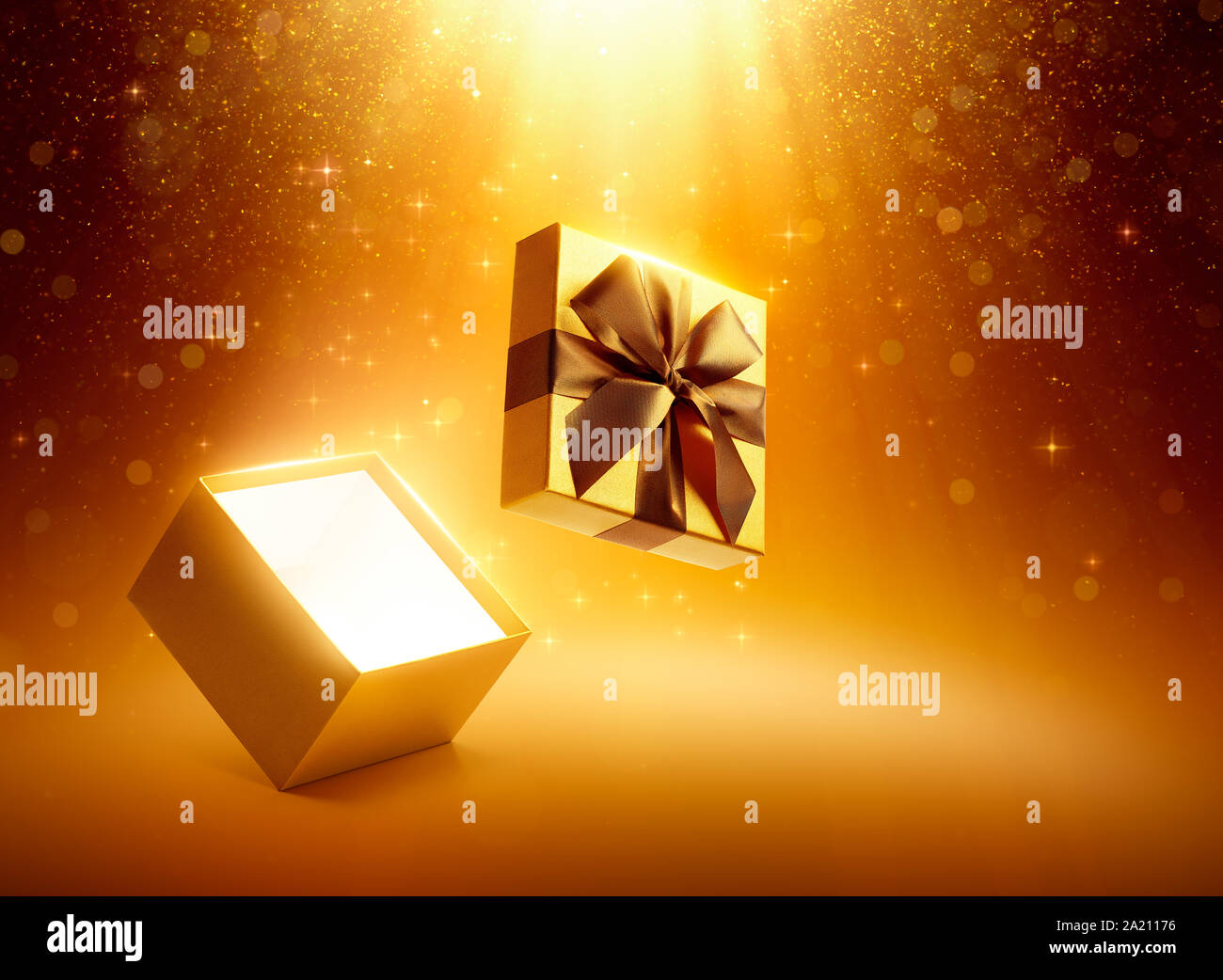 Gold open gift box on glittering background Stock Photo - Alamy