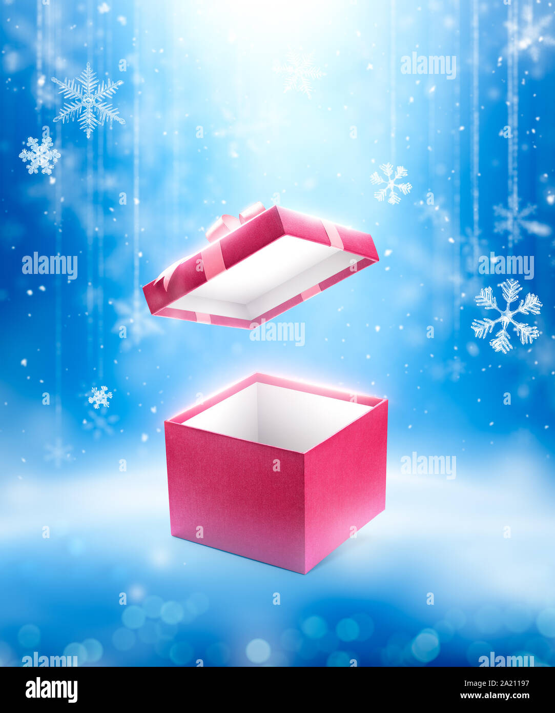 Red open gift box on fallen defocused snowflakes background Stock Photo ...