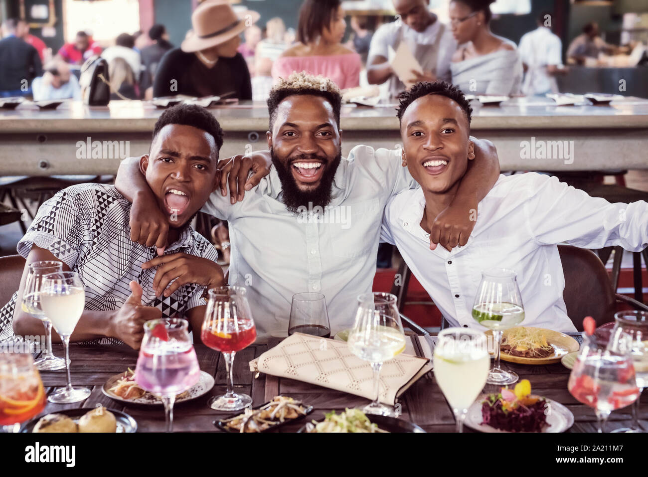Friends eating together at Urbanology Stock Photo - Alamy