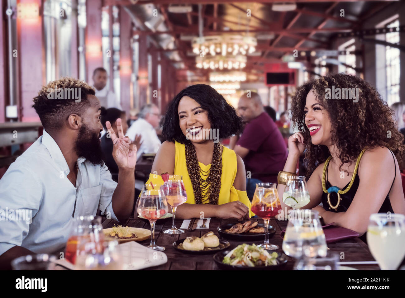 Friends eating together at Urbanology Stock Photo - Alamy