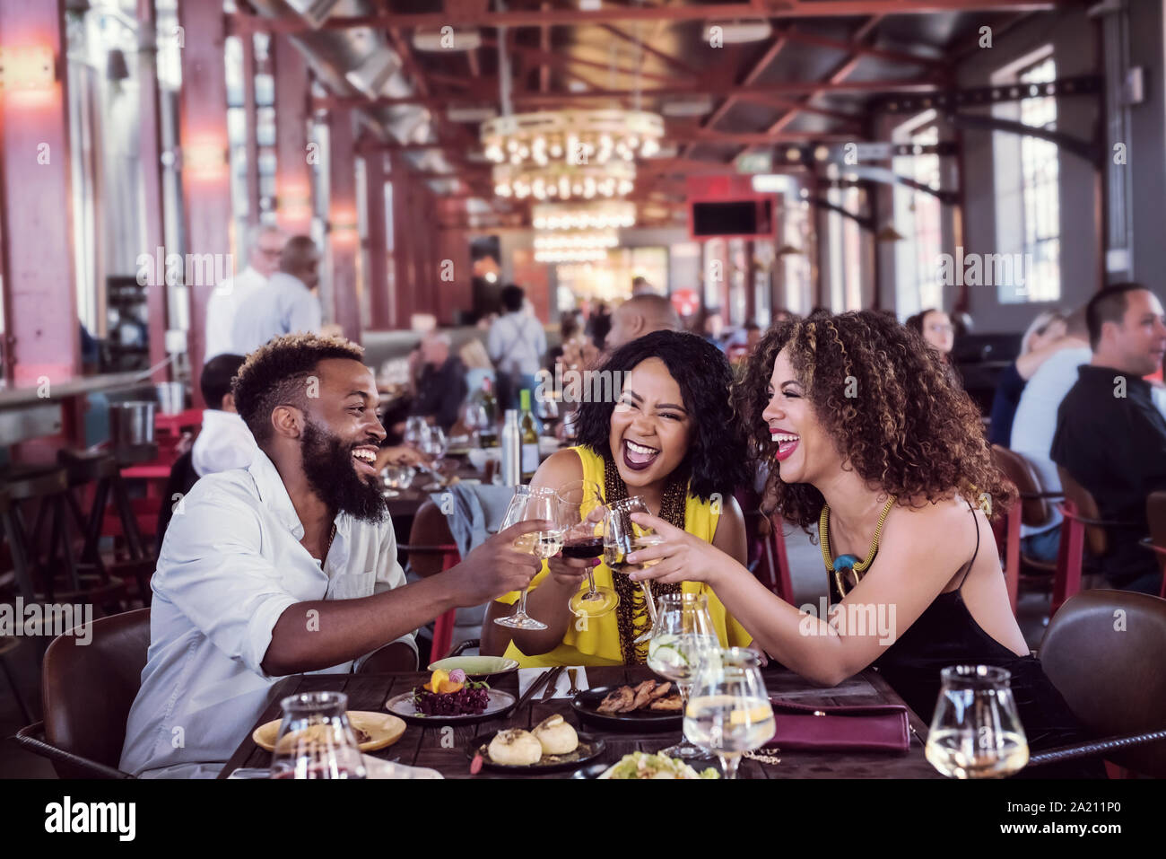Friends eating together at Urbanology Stock Photo - Alamy