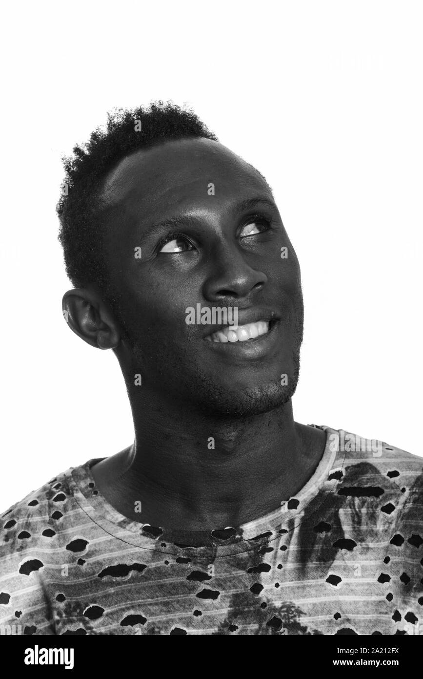 Face of young happy African man smiling and thinking Stock Photo - Alamy