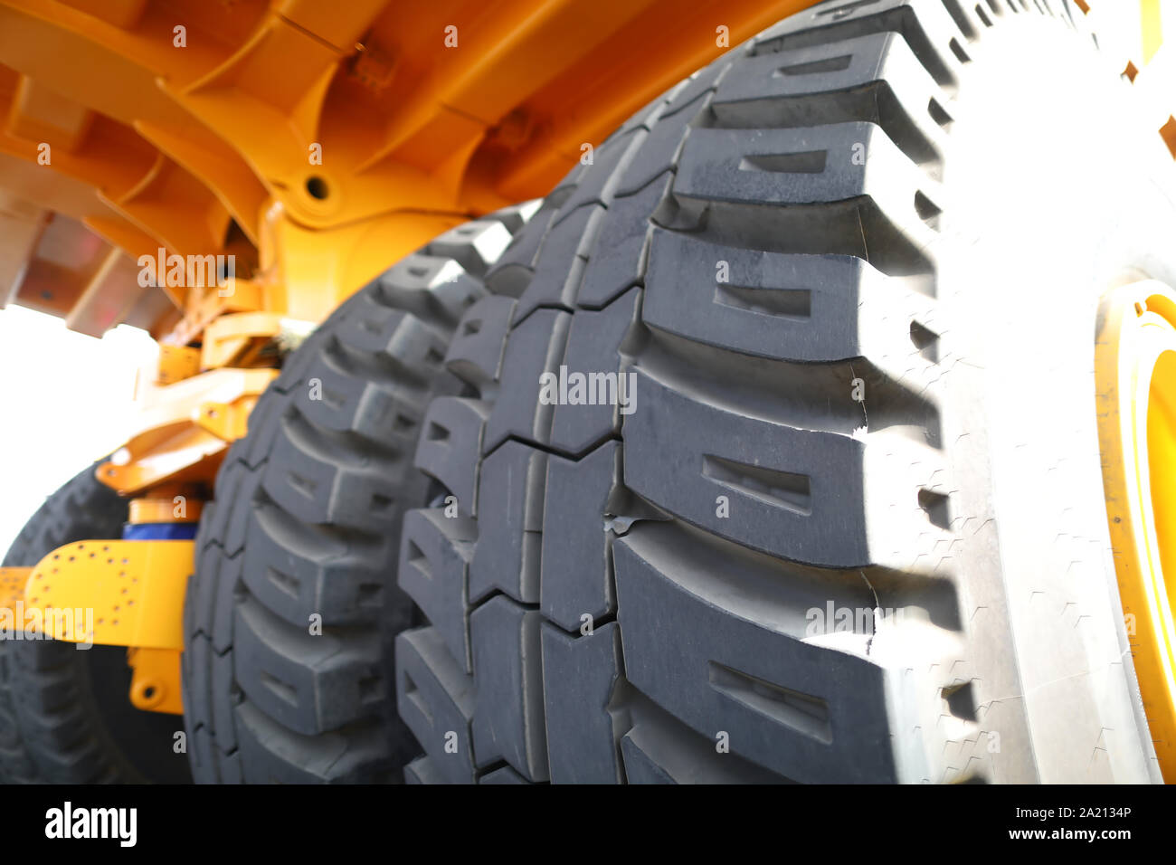 Huge rear wheels of dump truck at unusual angle Stock Photo - Alamy