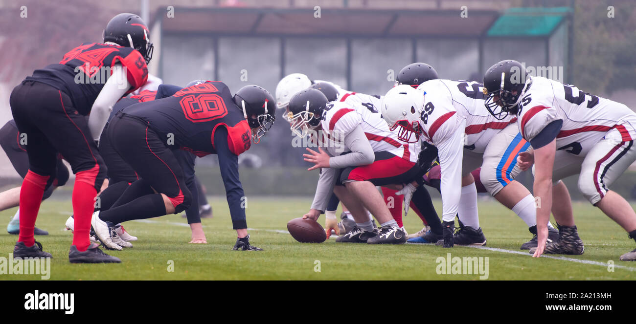 group of young professional american football players ready to start ...