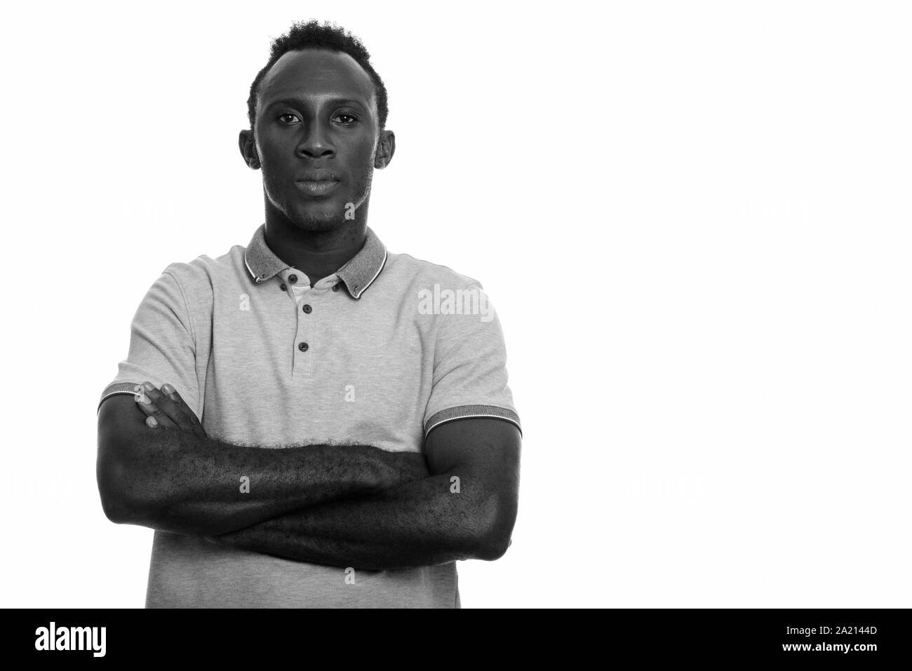 Young black African man with arms crossed Stock Photo - Alamy