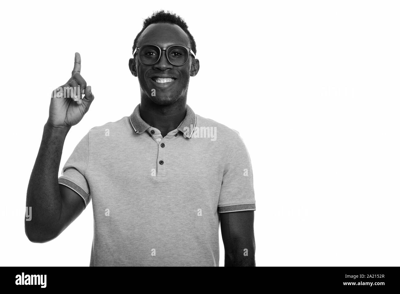 Young happy black African man smiling while pointing finger up Stock ...