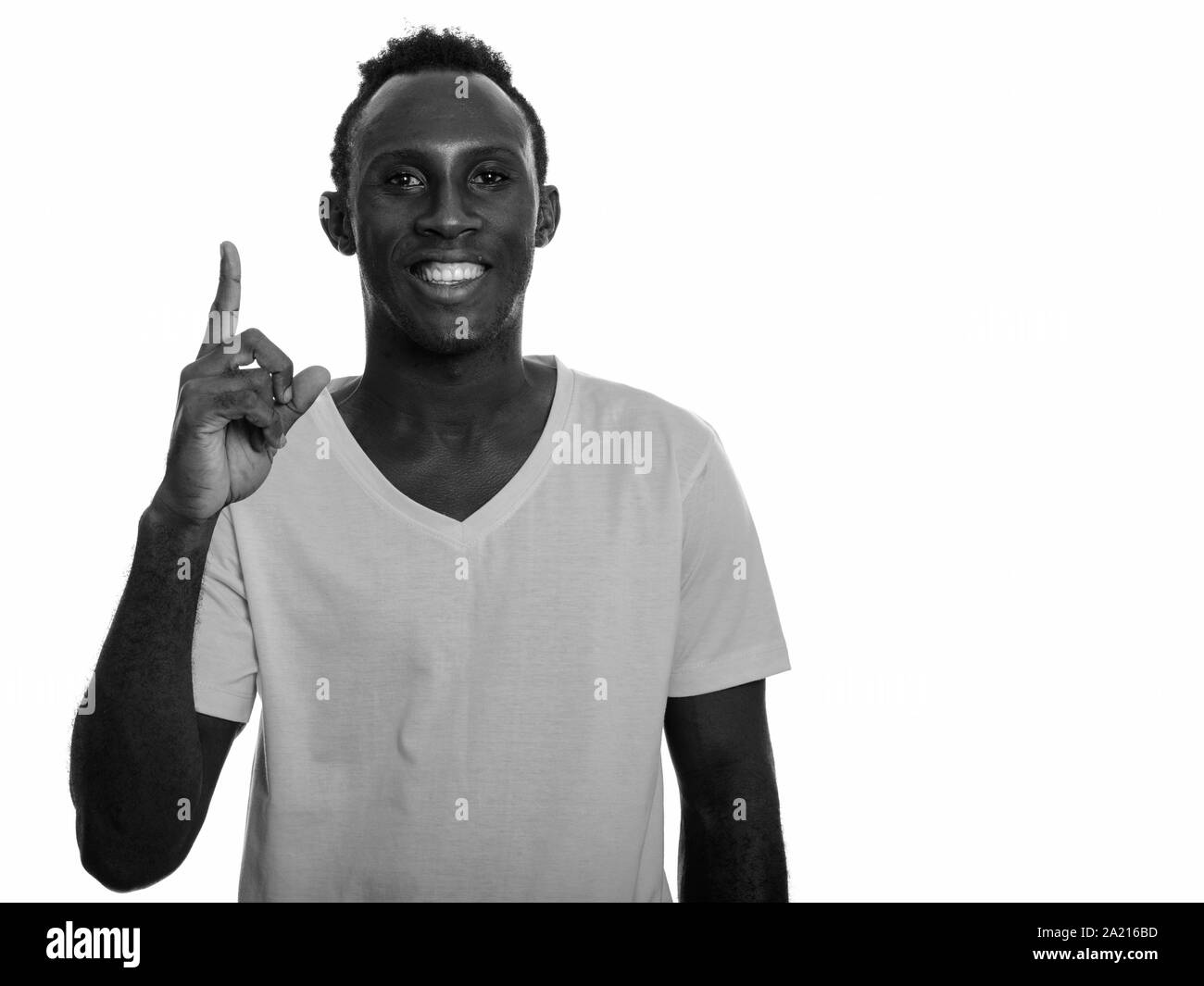 Young happy African man smiling and pointing finger up Stock Photo - Alamy