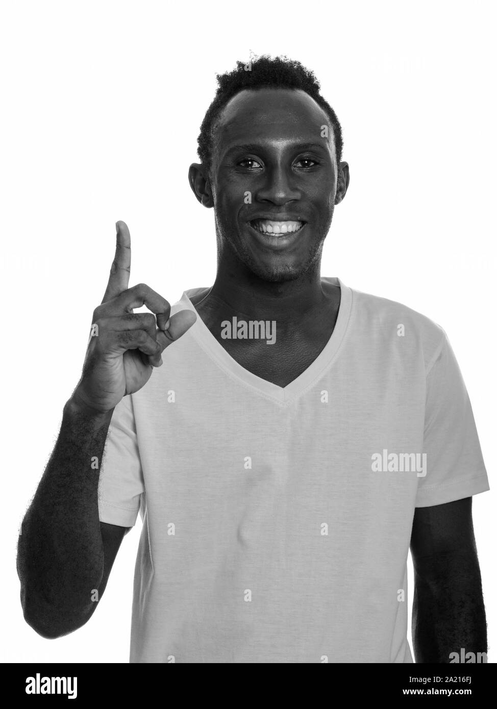 Young happy African man smiling and pointing finger up Stock Photo - Alamy