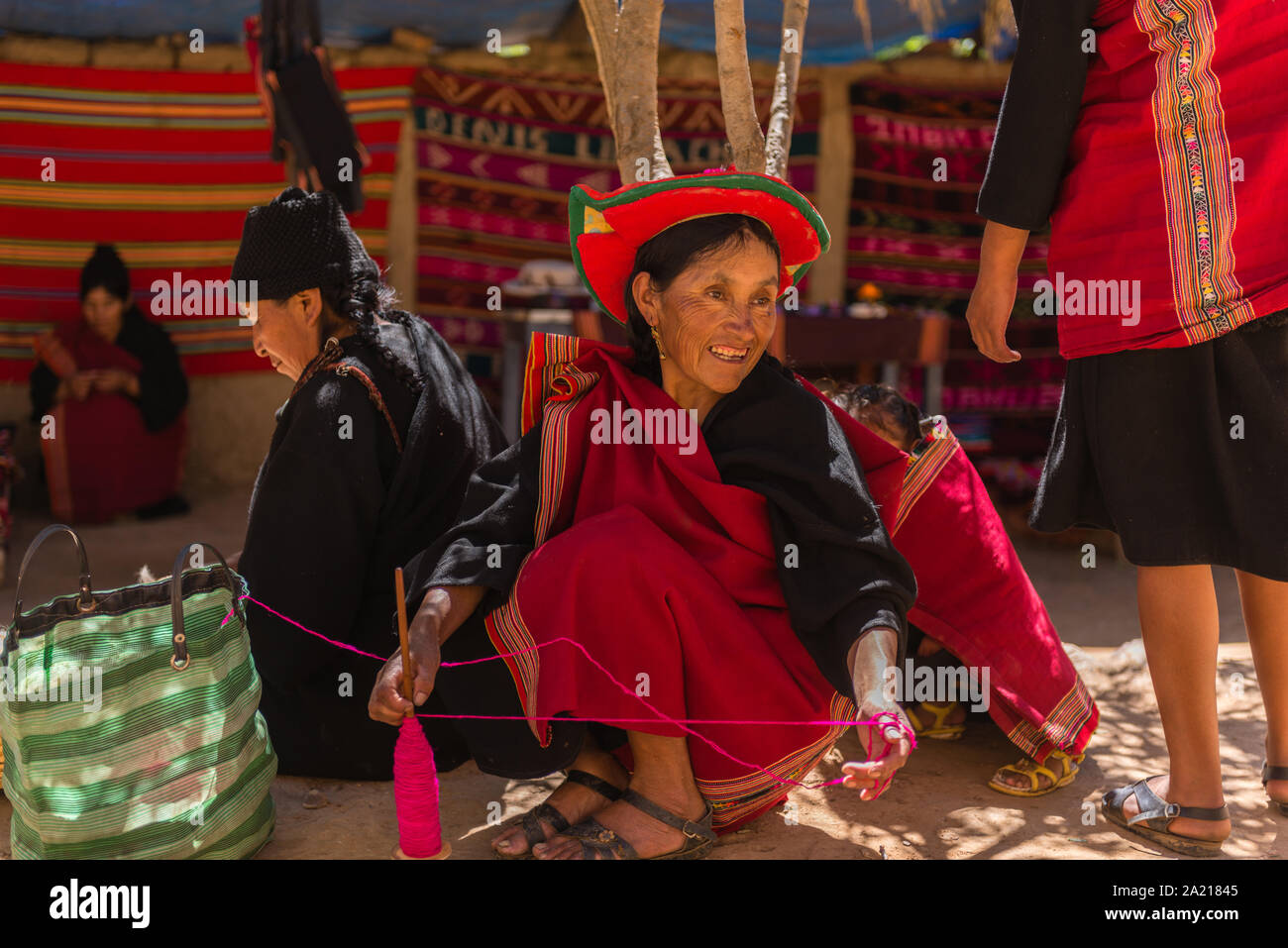 Women sitting, talking and knitting, indigenous village of Puka Puka near Tarabuco, meeting ...