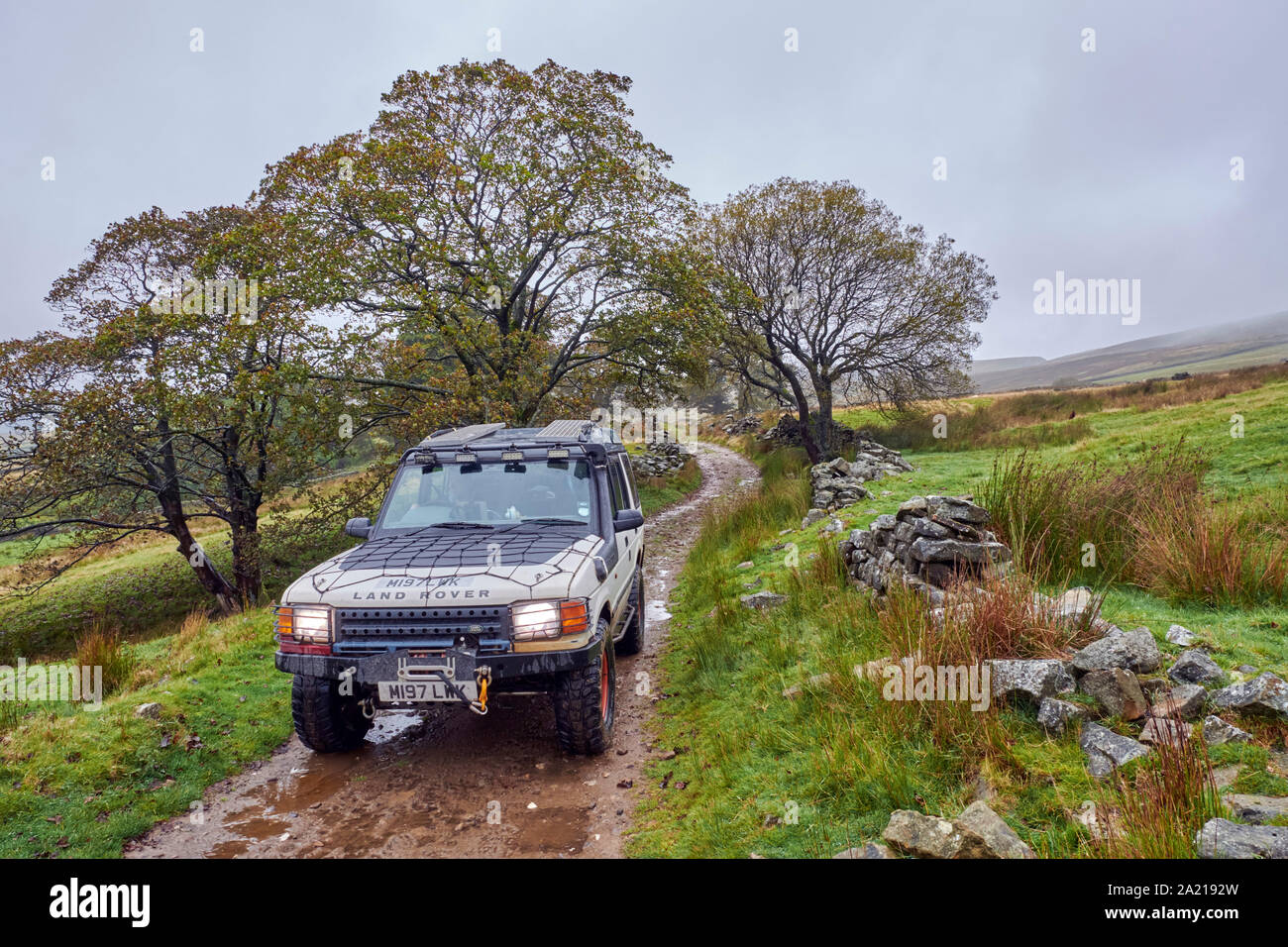 Car on unsurfaced road near Scar House Reservoir. Yorkshire Dales ...