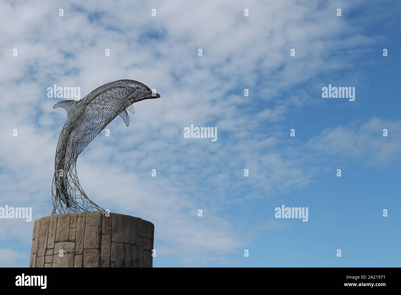 Metal dolphin statue, Portsoy harbour Stock Photo - Alamy
