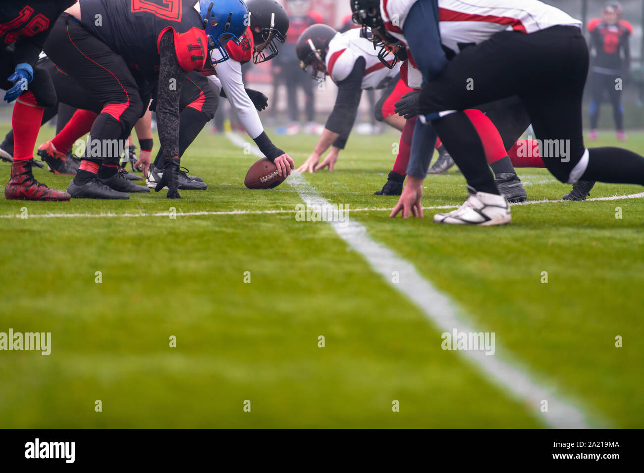 group of young professional american football players ready to start ...