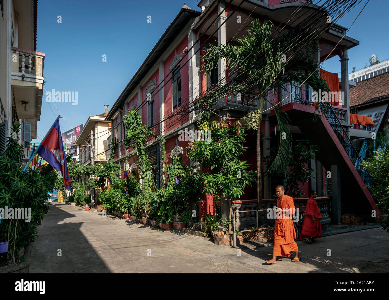 young buddhist monk walking in sunny phnom penh cambodia street inside ...