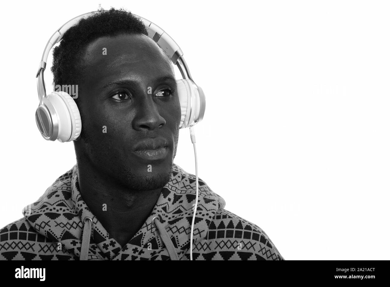 Young black African man listening to music while thinking Stock Photo ...