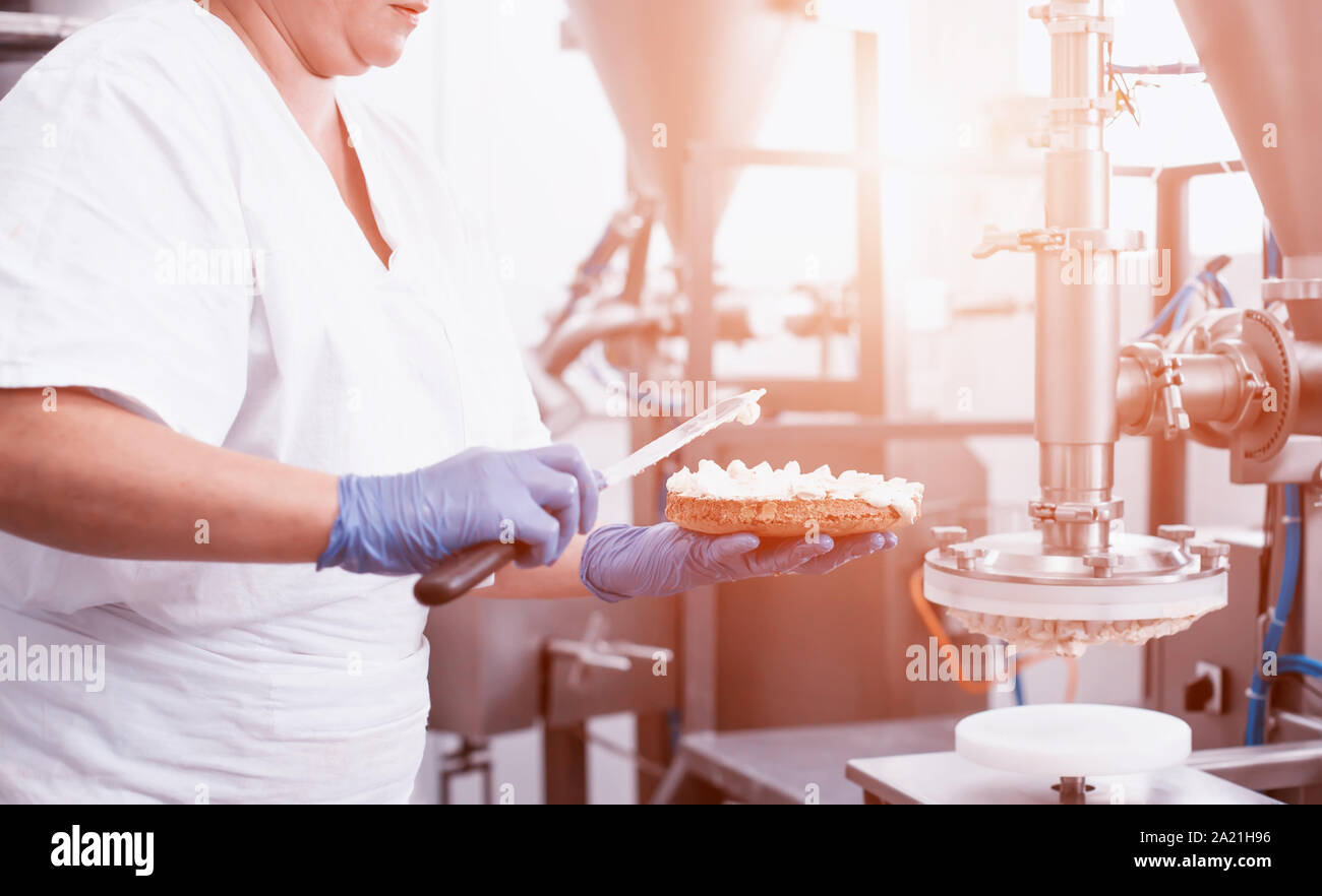 The pastry chef makes cake using modern equipment for the production of ...