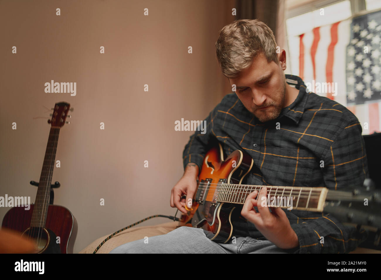 Man practices playing electric guitar hi-res stock photography and ...