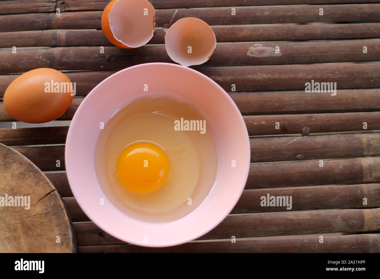 shell with egg and open Eggs in a pink bowl Placed near to the butcher ...