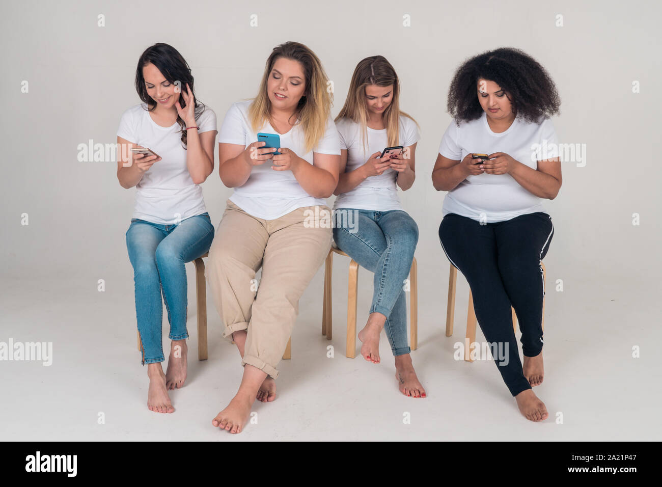 Girls sitting on chairs hi-res stock photography and images - Alamy